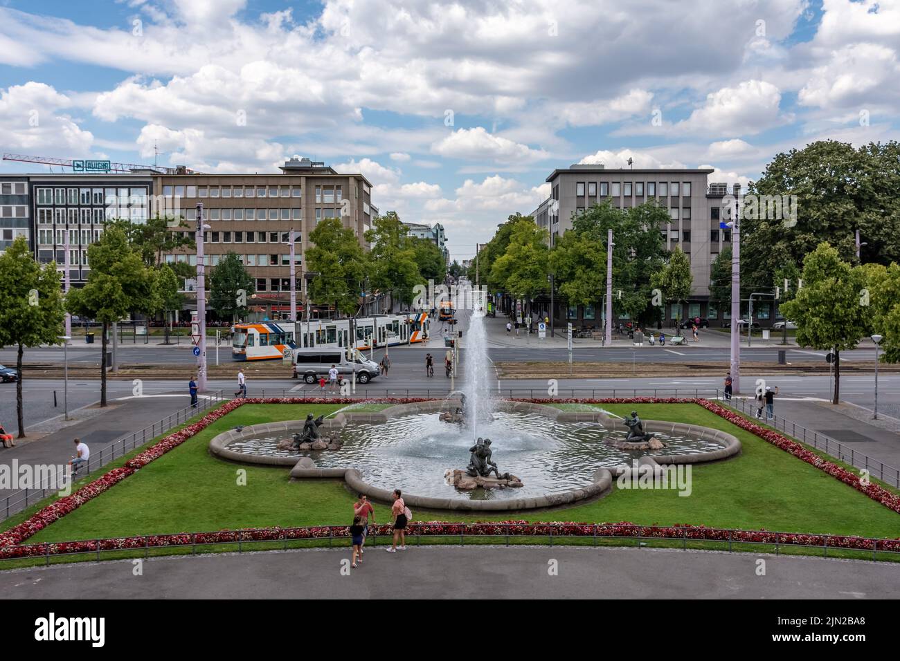 The high-angle view of the decorative water fountain with the view of Mannheim city buildings ...