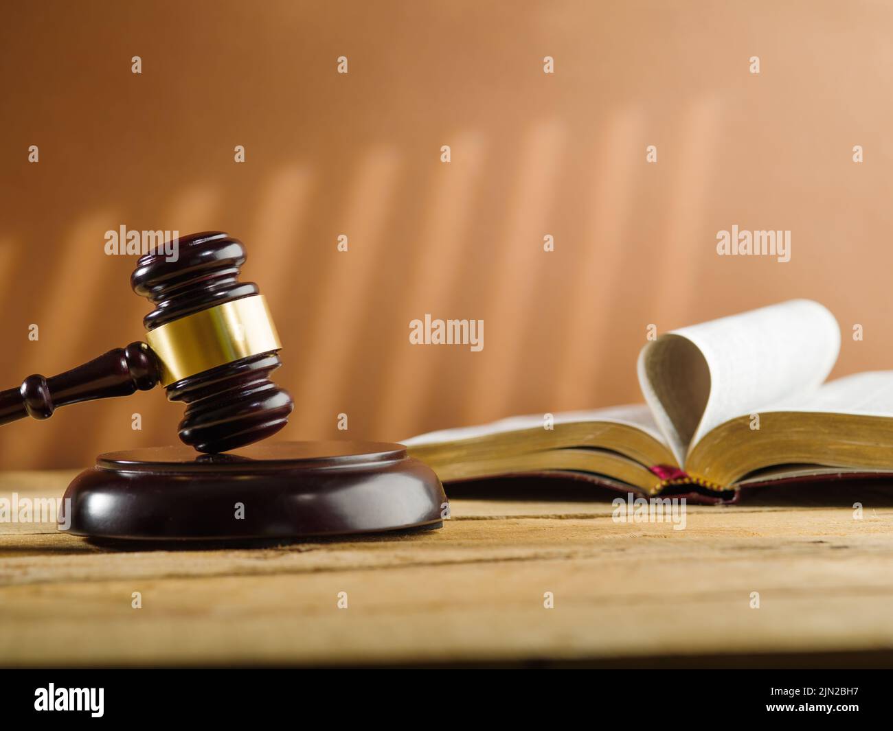 Judgment and justice. On a beige background, an open book and a wooden ...