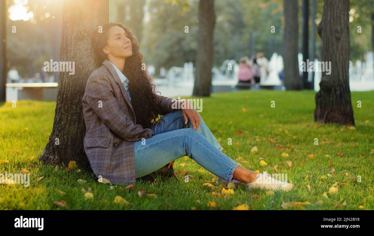 Calm relaxed young business woman beautiful girl with long curly hair ...