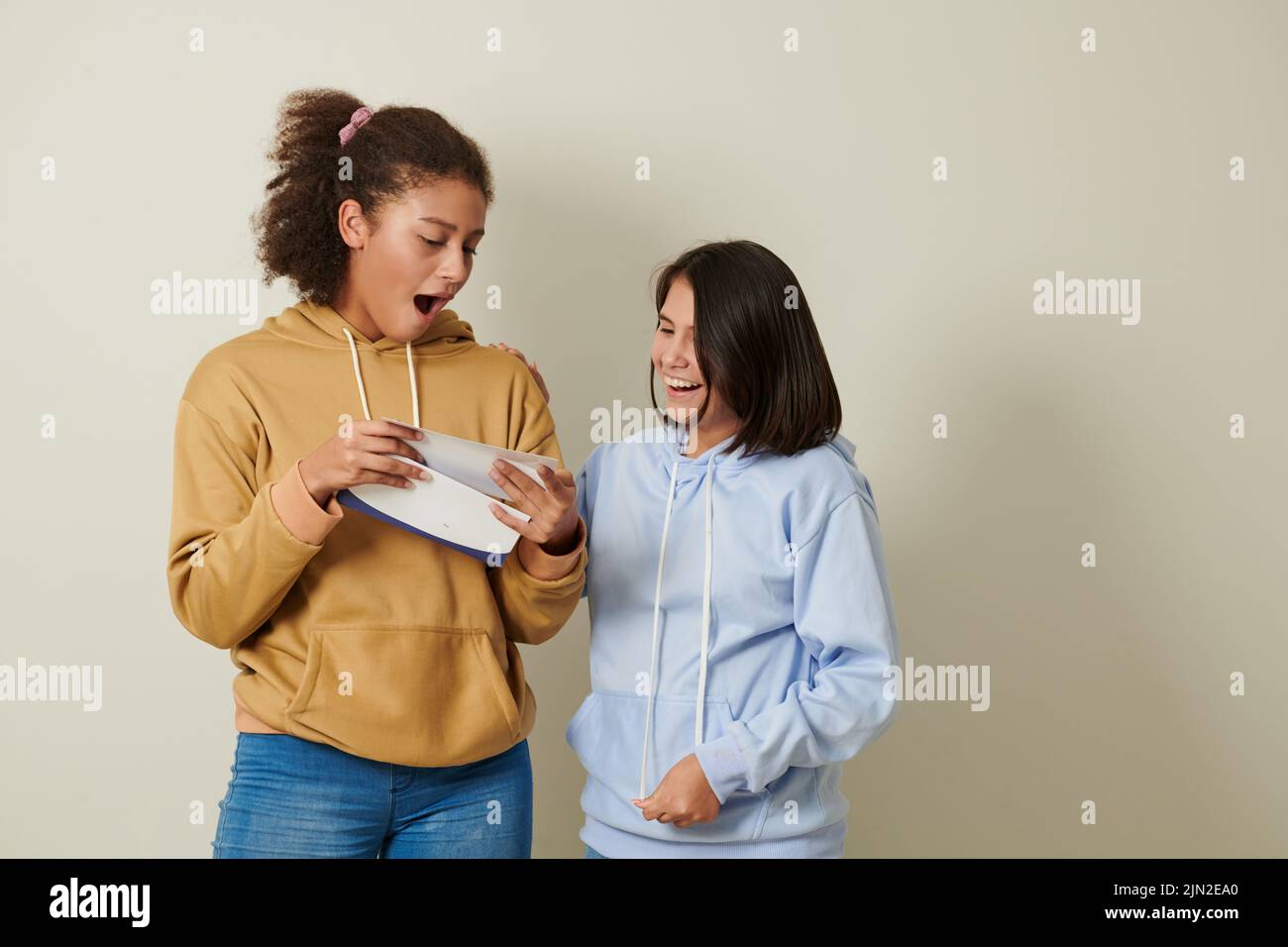 Friends congratulating girl receiving acceptance letter from college ...
