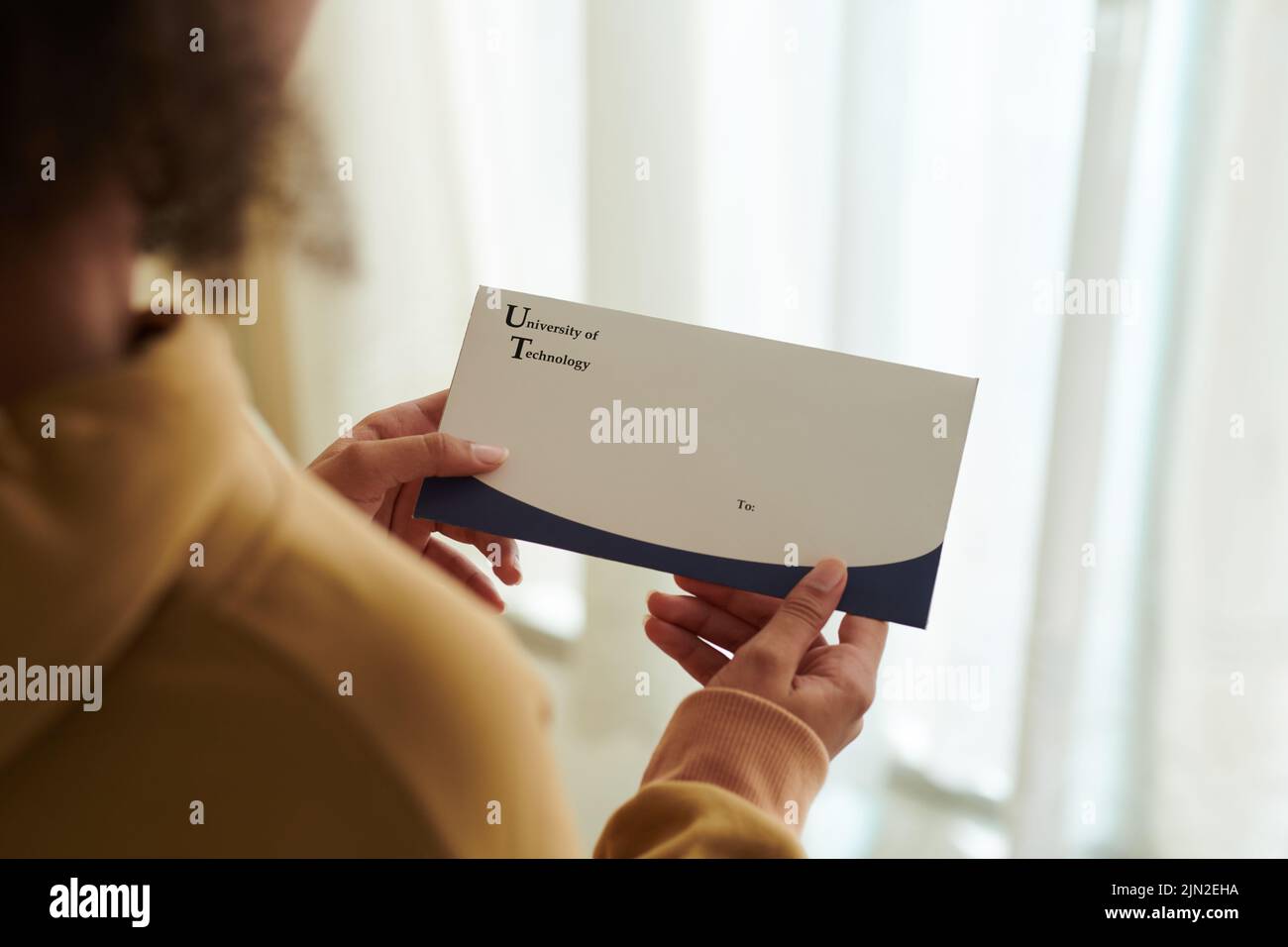 Teenage girl holding acceptance letter from university Stock Photo - Alamy