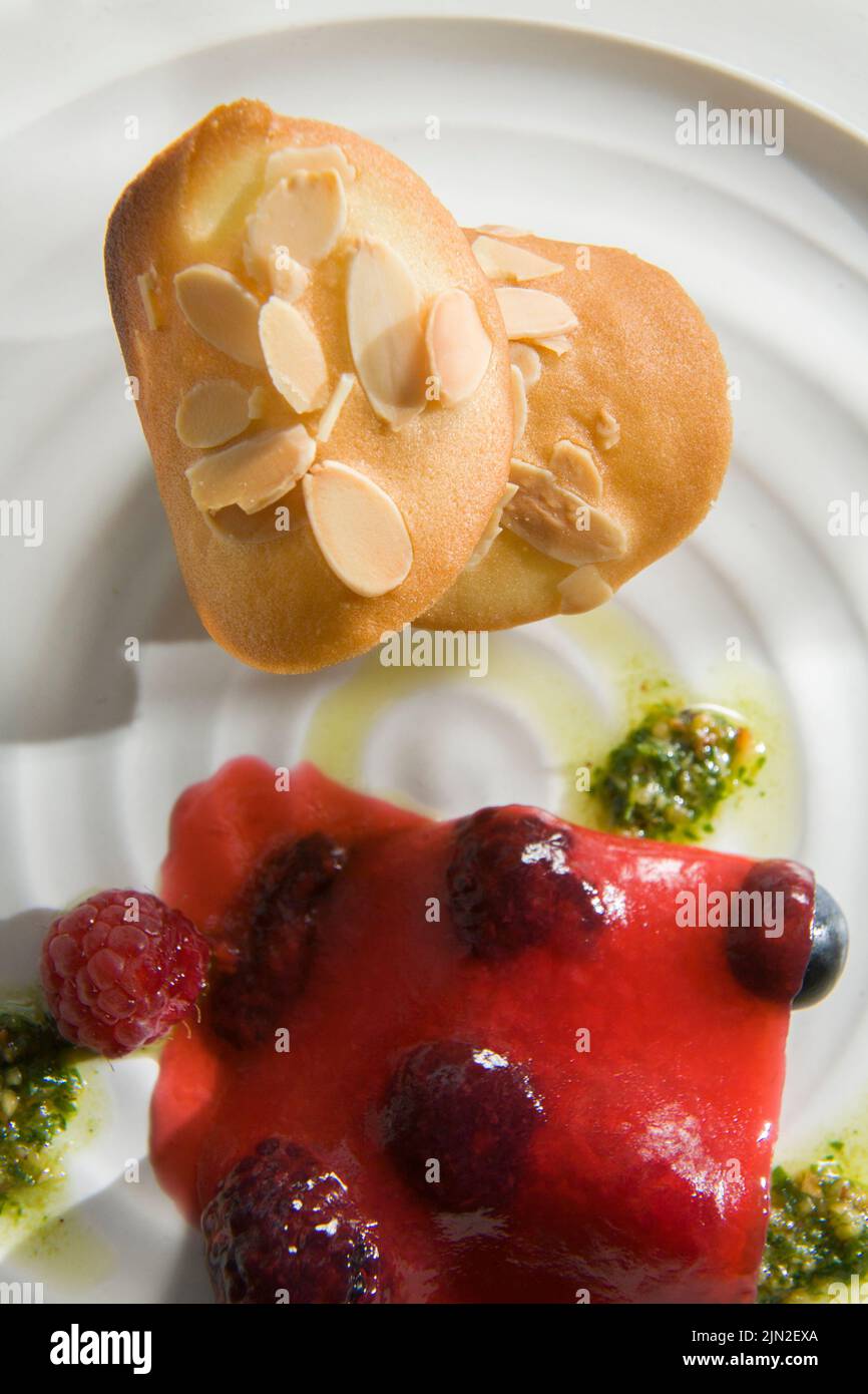 Goats cheese topped with nutty biscuit, raspberries with gelatinesed ...