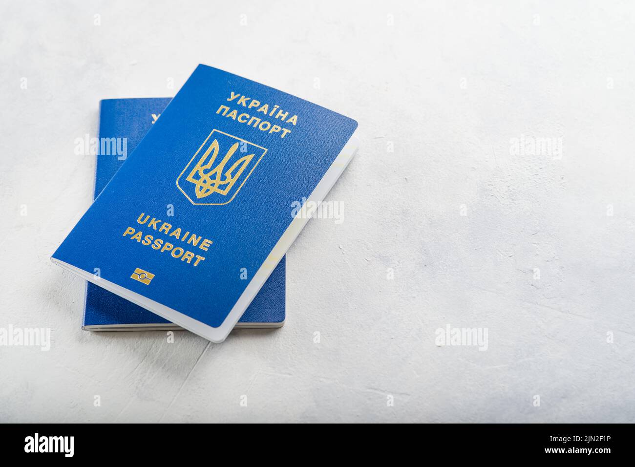 Two Ukrainian passports on a white background. Minimalism. There are no ...