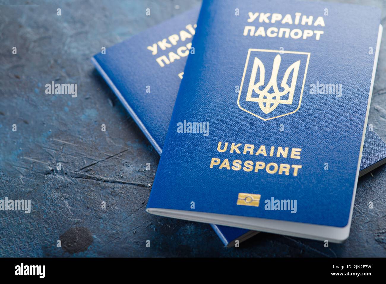 Close-up. Two Ukrainian passports on a dark blue background. Symbol of ...