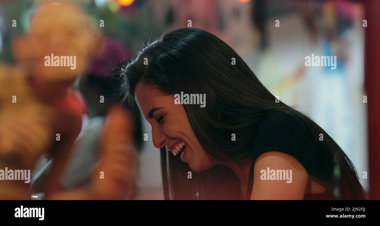 Night scene of Candid casual young women talking to person off-camera ...