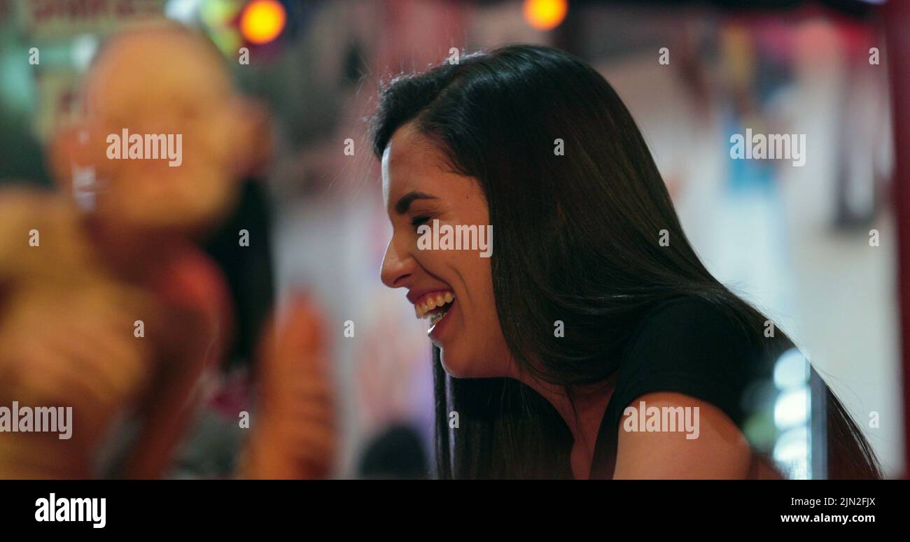 Night scene of Candid casual young women talking to person off-camera ...