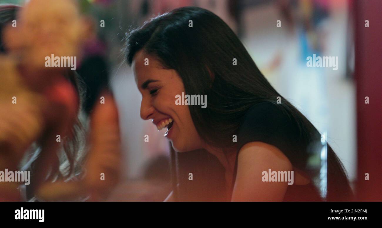 Night scene of Candid casual young women talking to person off-camera ...