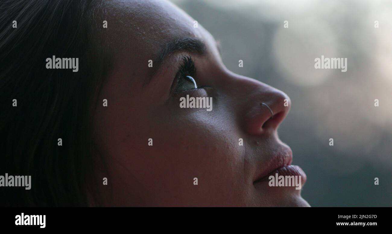 Young woman face opening and closing eyes. Girl meditating and in ...