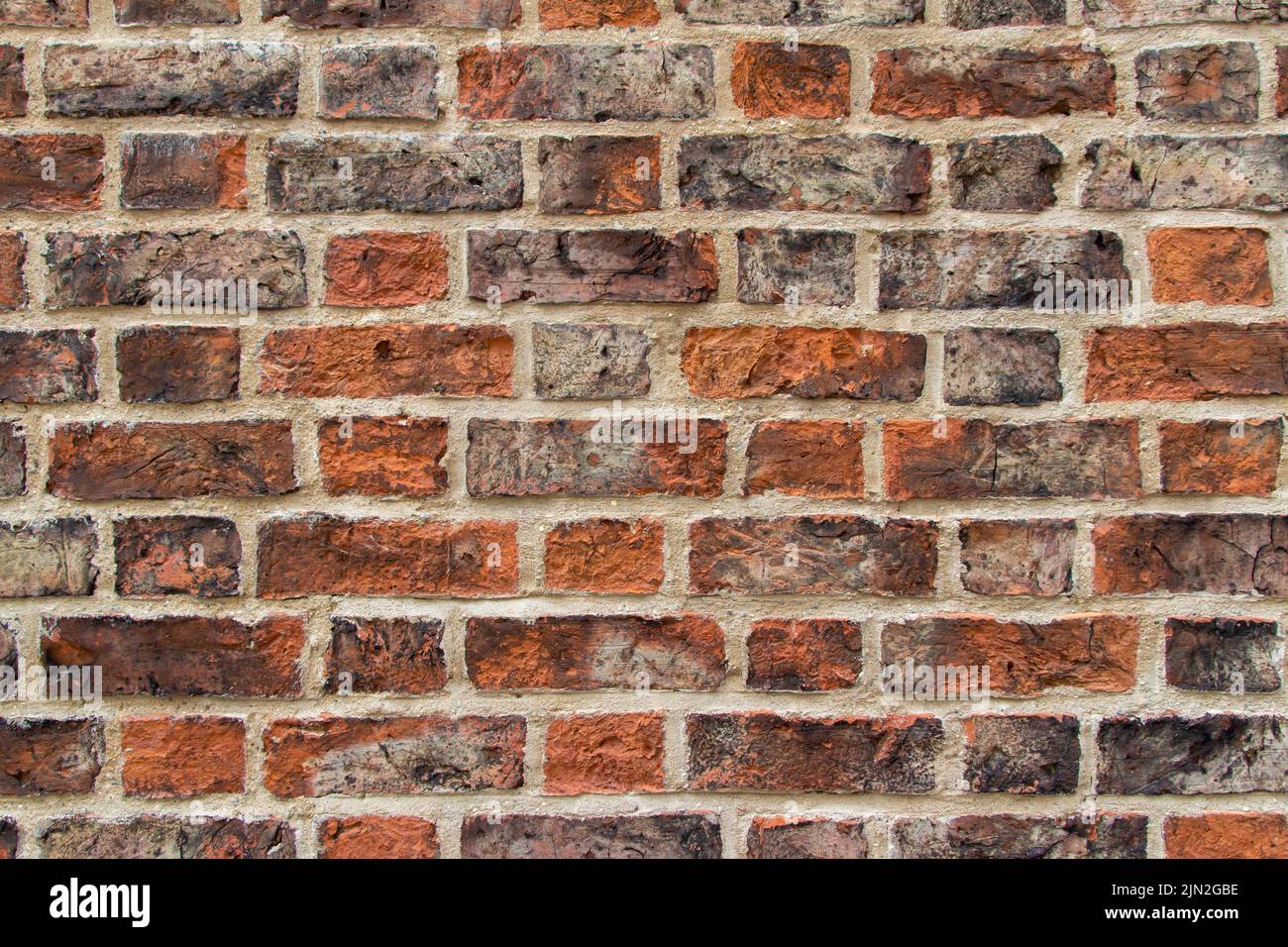 Full frame texture background of a European red color brick wall with a ...