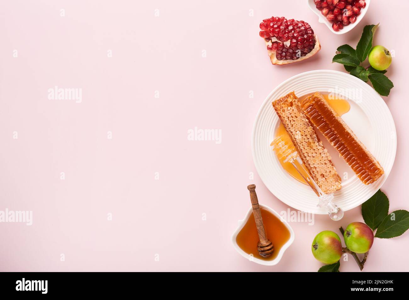Rosh Hashanah. Honey jar, honeycomb, apple and pomegranate on simple ...