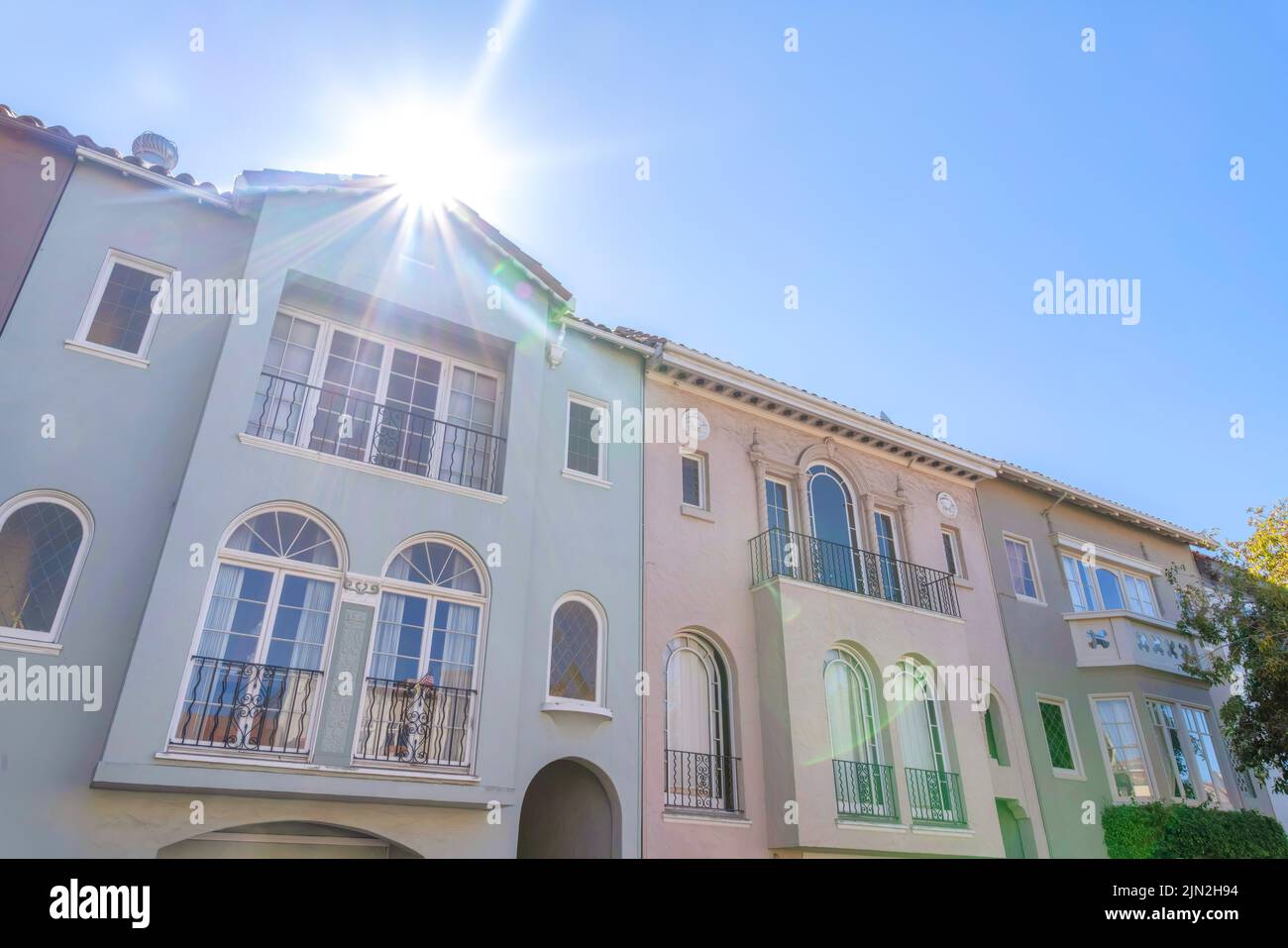 Sun above the row of mediterranean adjacent houses at San Francisco ...