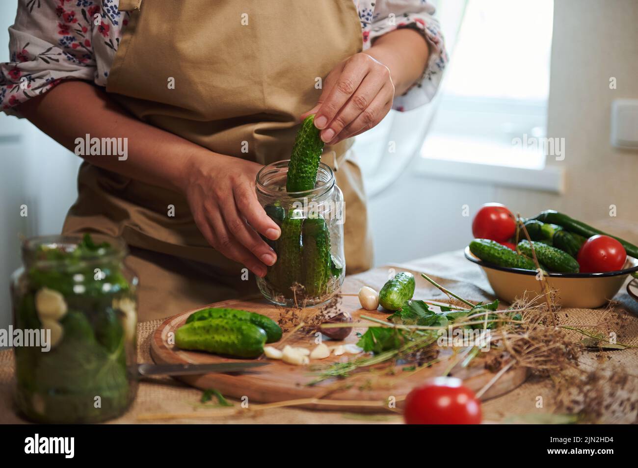 Woman cutting putting cucumbers dill hi-res stock photography and ...