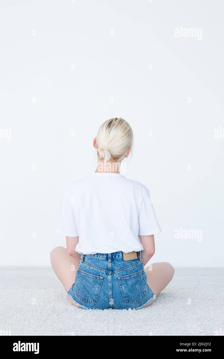 backview woman sit look invisible object white Stock Photo - Alamy