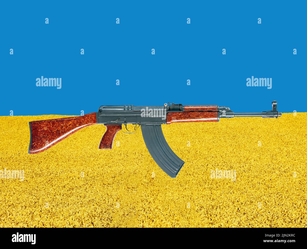 An old assault rifle on a background of a blue sky with yellow grain ...