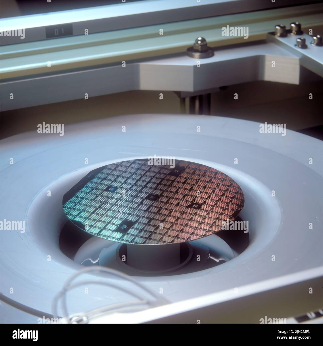 A close up of a computer microchip wafer being manufactured Stock Photo ...