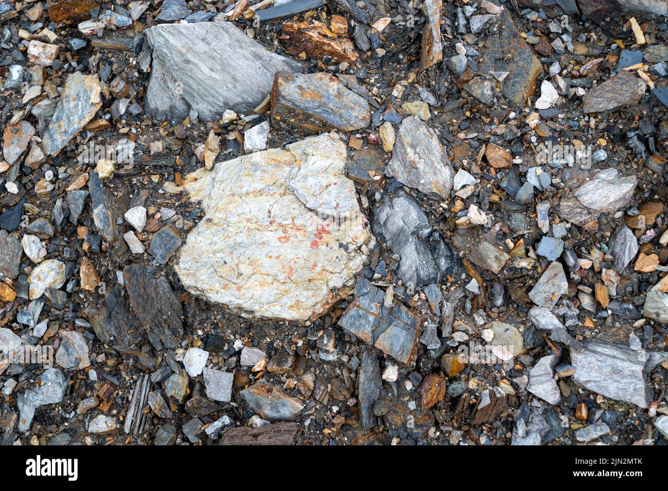 Gravel and rock texture back ground in wet condition. Big rock is on ...