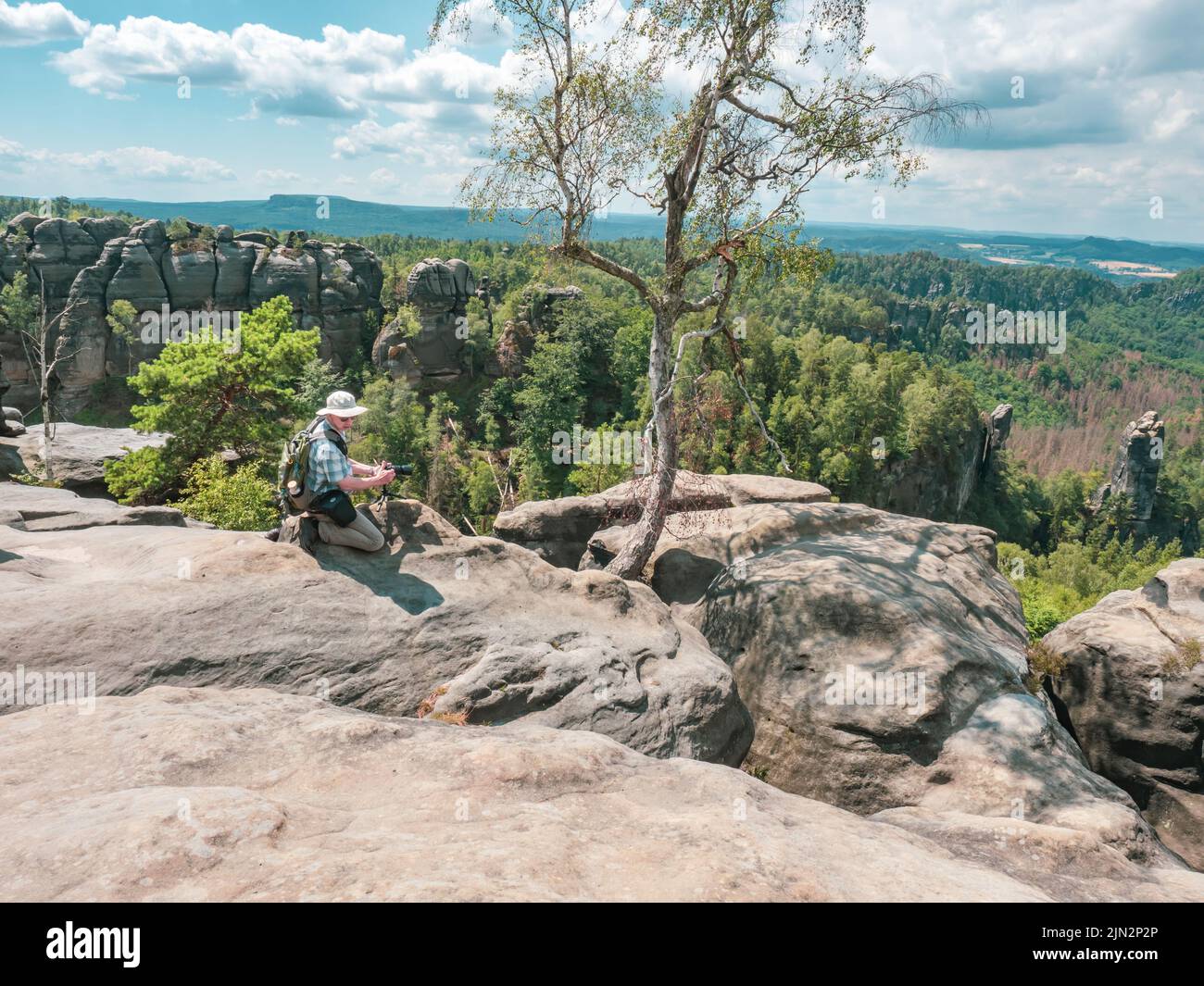 Schmilka - Germany, July 06, 2022: Tourist with camera is taking photos ...