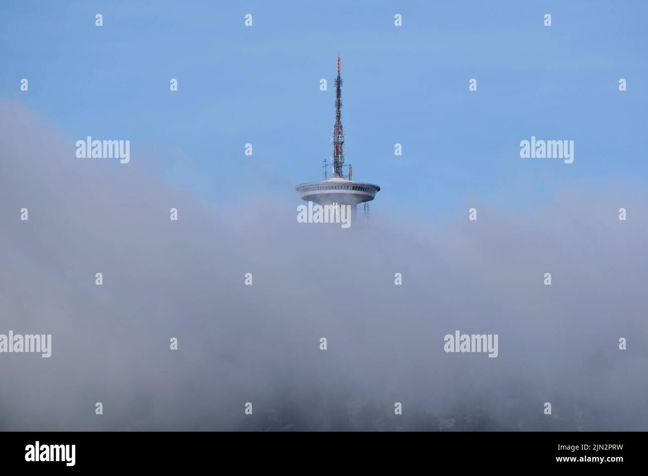 Clouds hiding an antenna in mount Parnitha, Greece. Telecommunication ...