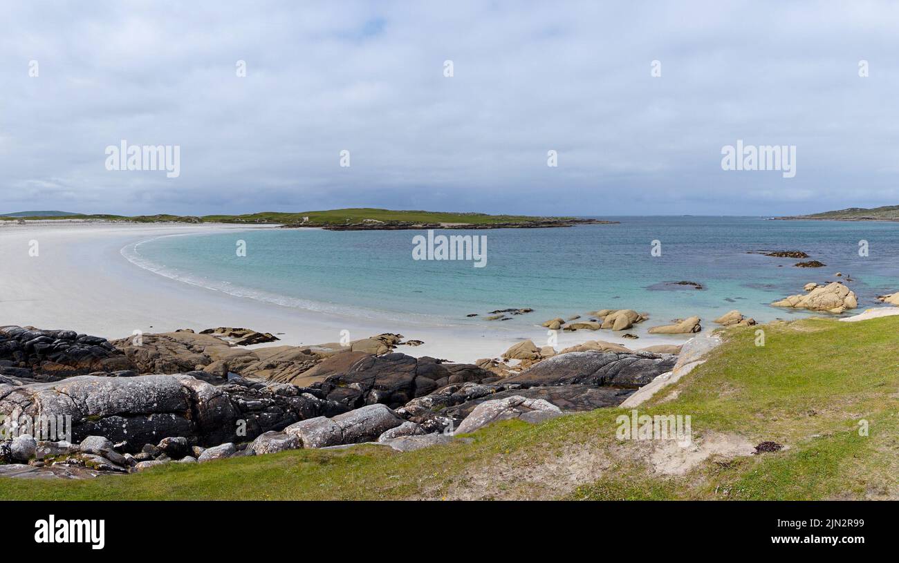 A panorama beach landscape of Dog's Bay with large granite boulders in ...