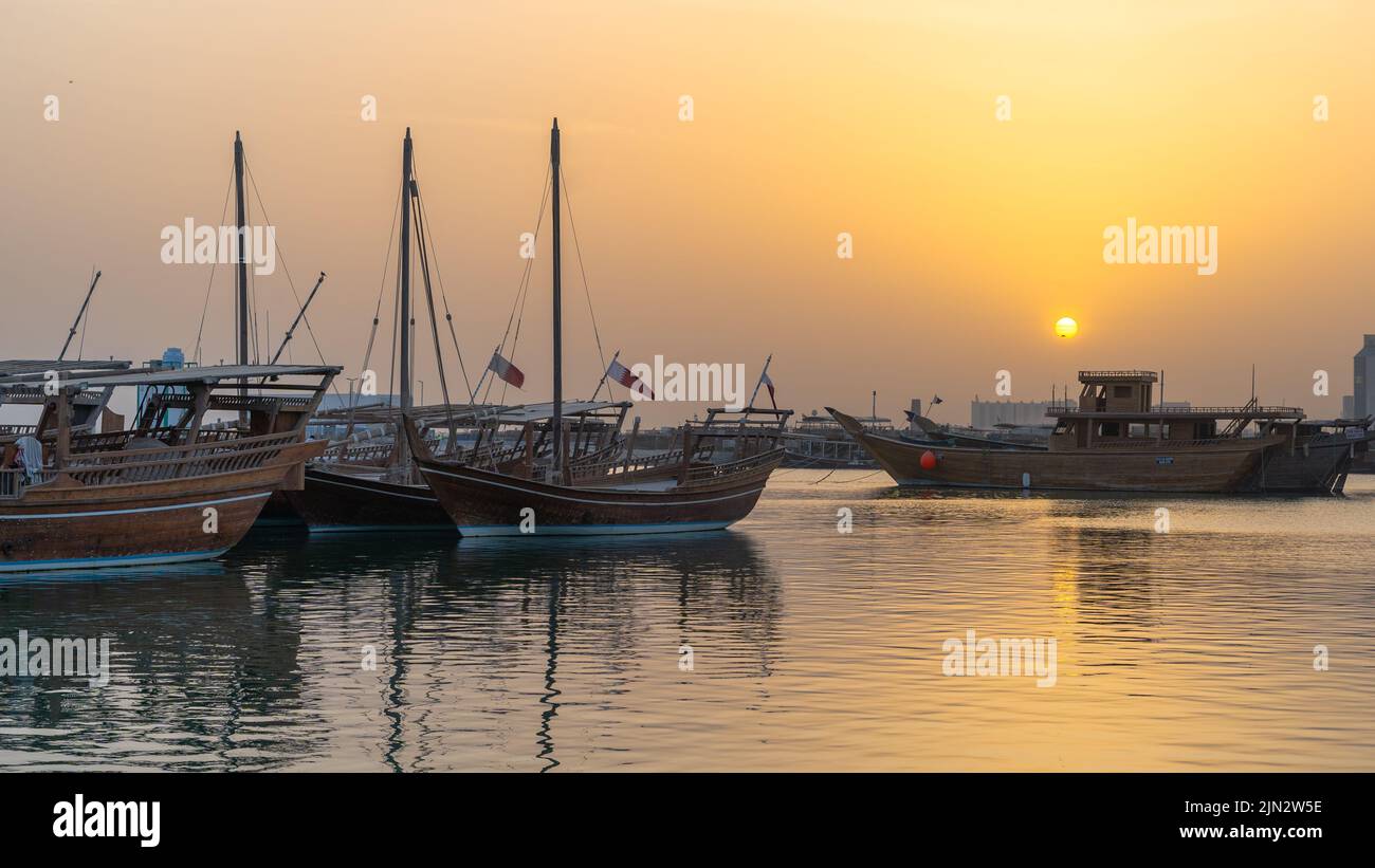 Multiple wooden traditional fishing dhows docked in the doha corniche ...