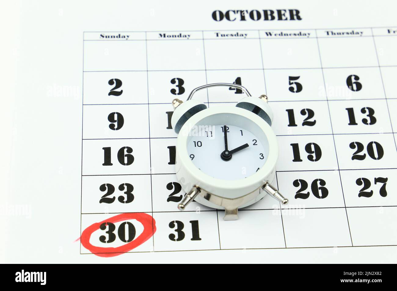 Clock marking winter time change over october calendar Stock Photo - Alamy