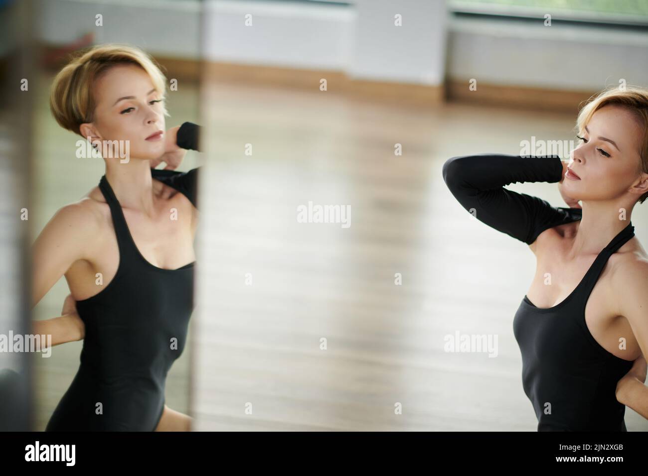 Professional female dancer dancing in front of mirror in studio Stock ...