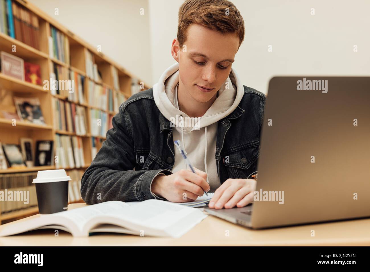 Man writing studying in library hi-res stock photography and images - Alamy