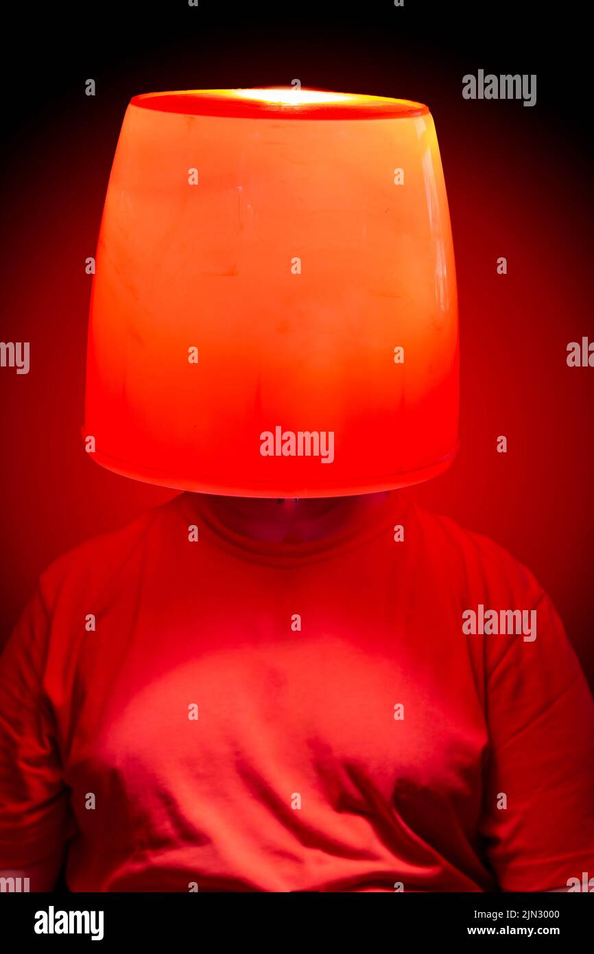 A vertical shot of a man wearing a red flower pot on his head Stock ...