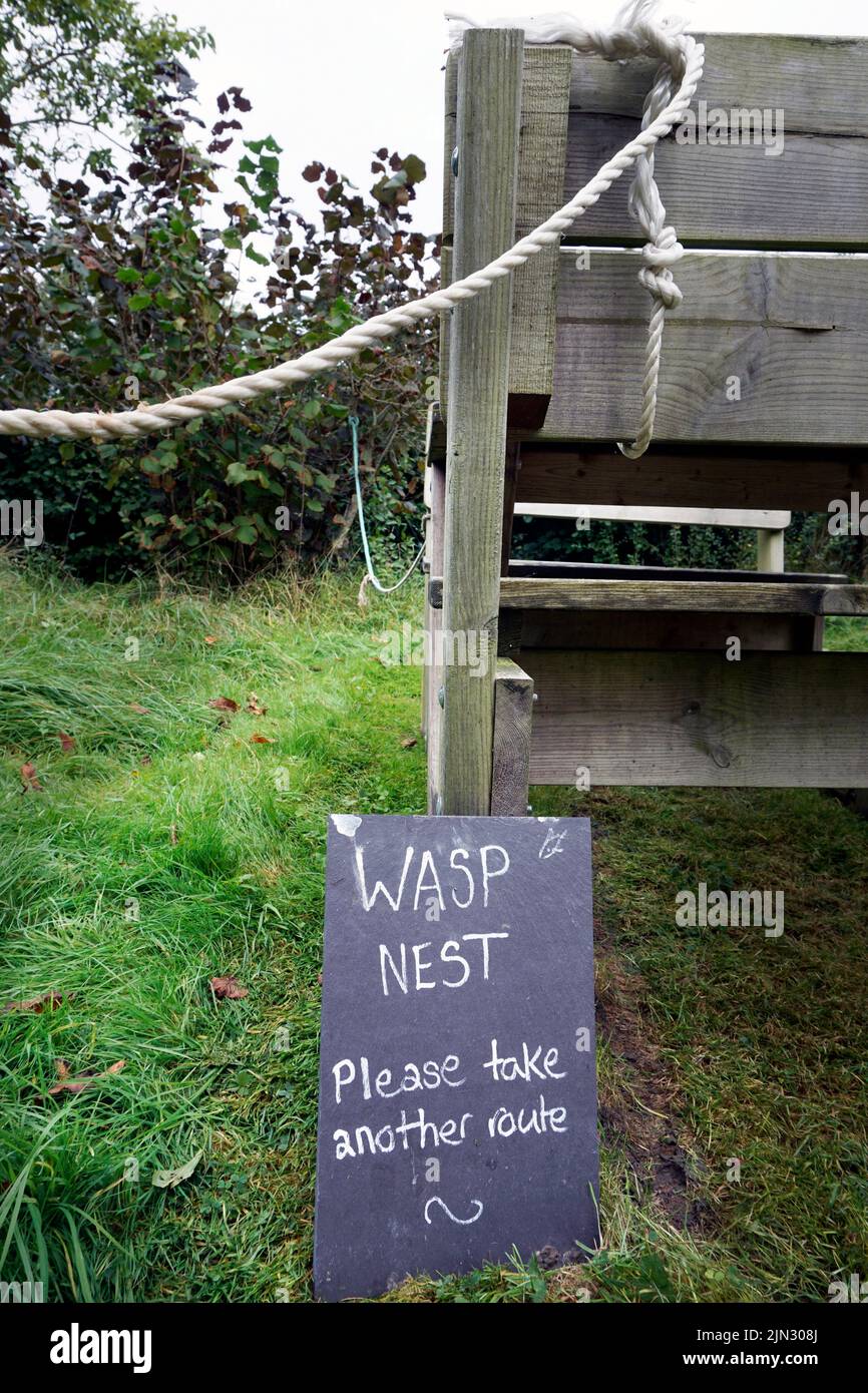 wasp nest warning sign Stock Photo - Alamy
