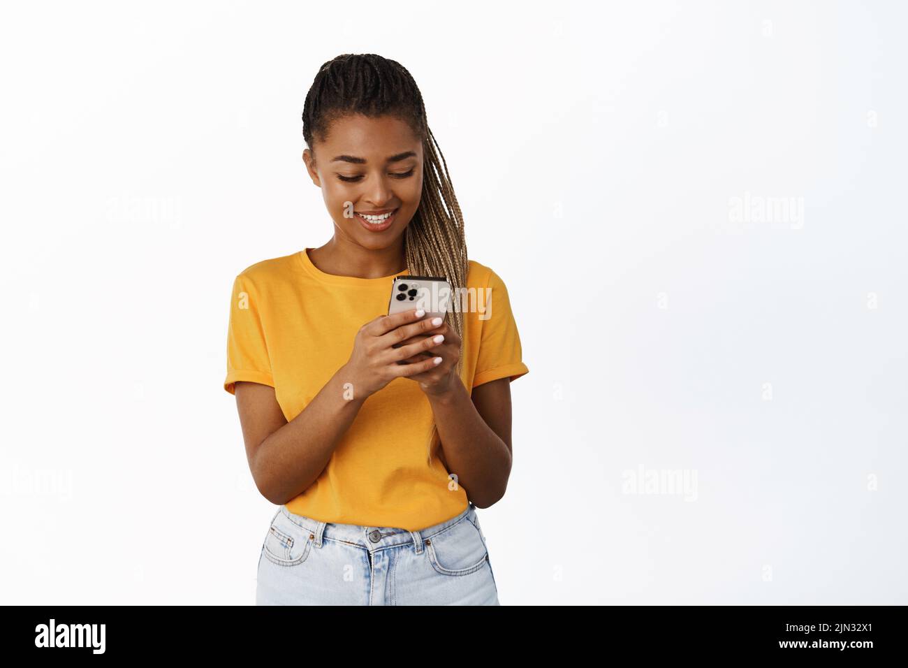 Smiling african american girl chatting on mobile messanger, using ...