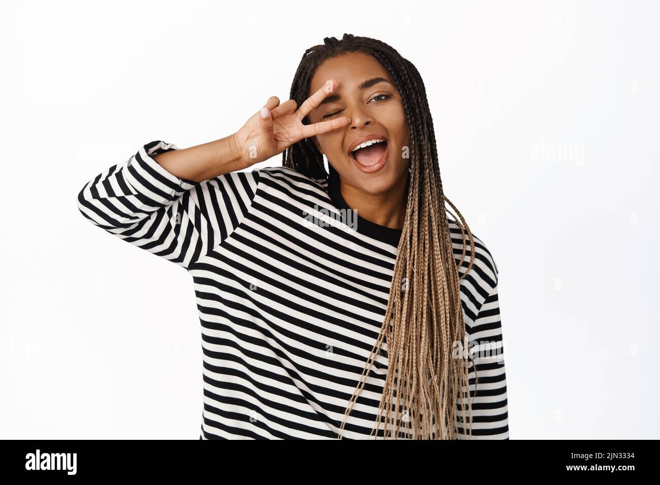 Portrait of happy and positive black girl shows peace, v-sign and ...