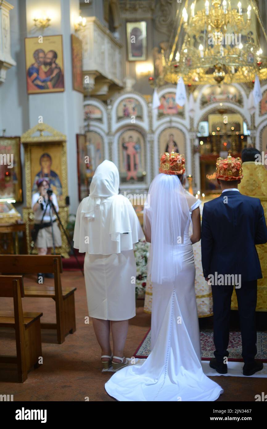 View at a wedding in Oortodox Church, candles Burning in the Temple ...