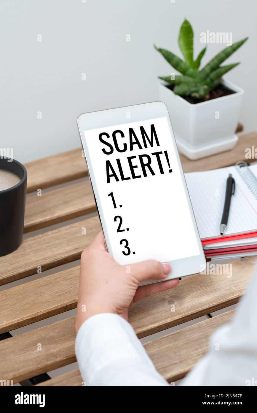 Sign displaying Scam Alert. Word Written on warning someone about ...