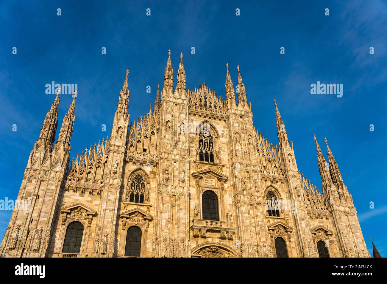 Sunset Scene of The ornate gothic facade, soaring spires and ...