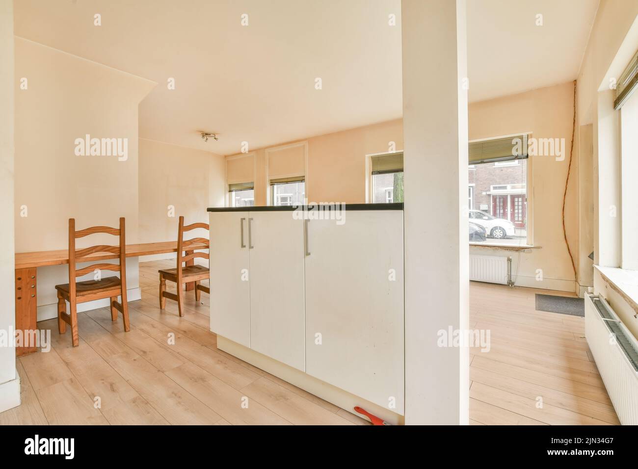 Interior of empty white kitchen with corridor and wooden parquet floor ...