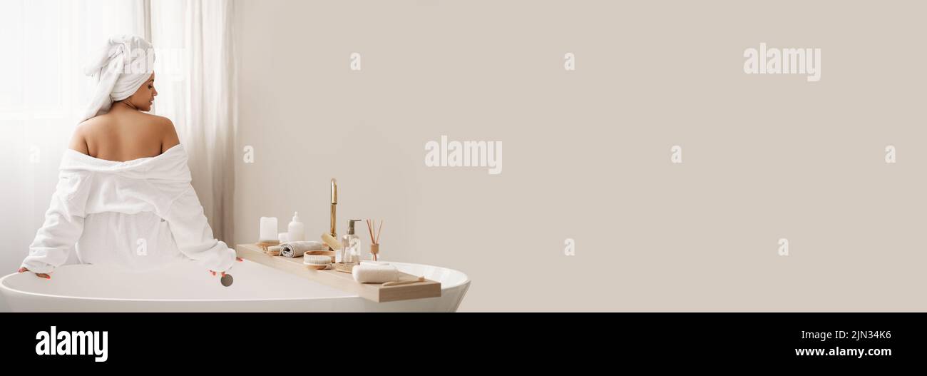 Woman Sitting On Bathtub Back To Camera, Copy Space Stock Photo - Alamy