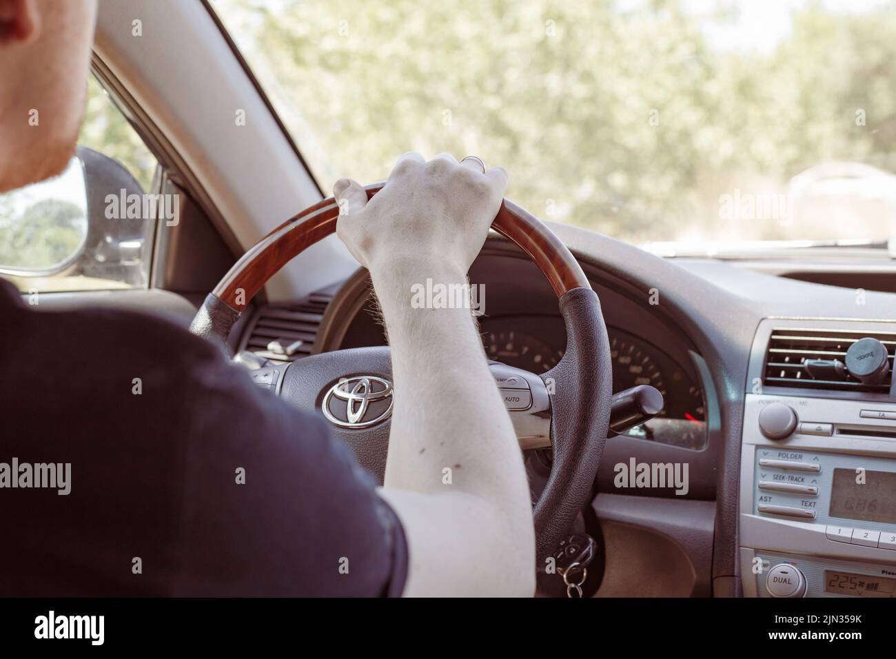A man driving a Toyota, view from the passenger compartment. Safe ...