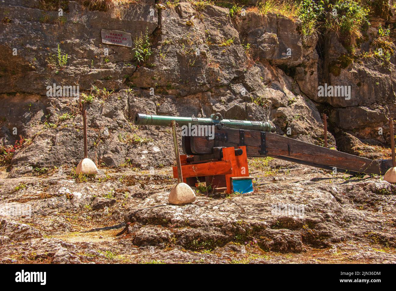 An ancient cannon stands on the pier near the fortress walls of the ...