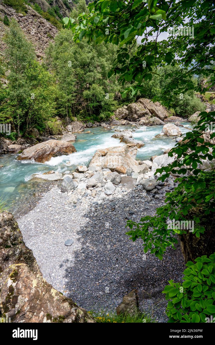 turquoise water river runs down from the mountains of the cirque de ...