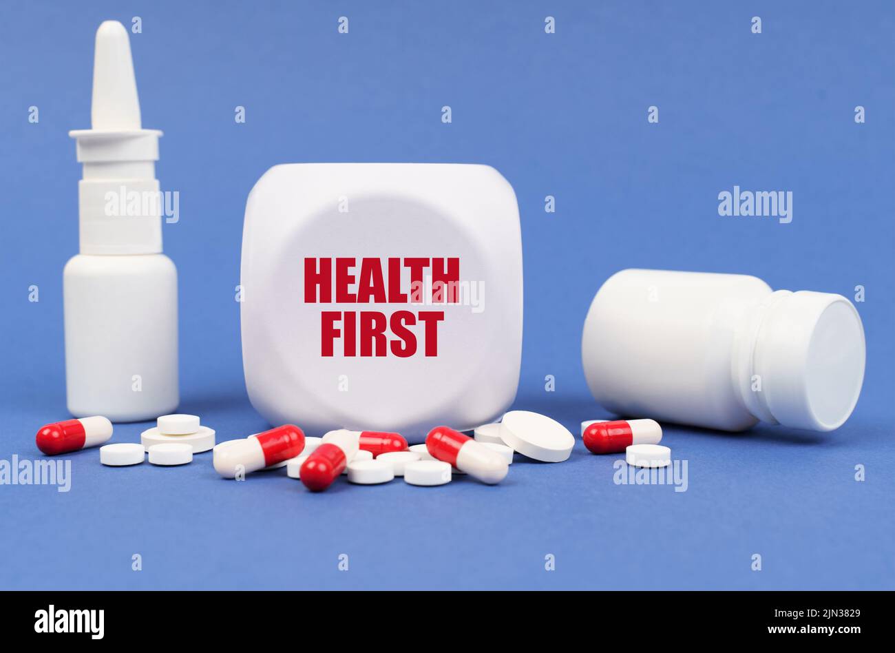 Medical concept. On the blue surface of the pill, capsule, spray, jar ...