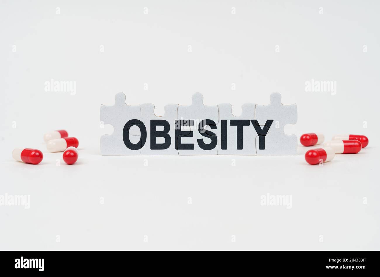 Medical concept. On a white surface are tablets and puzzles with the ...