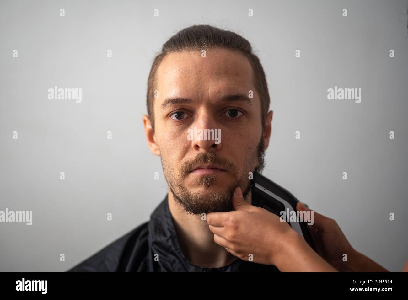 Young guy gets haircut hair hi-res stock photography and images - Alamy