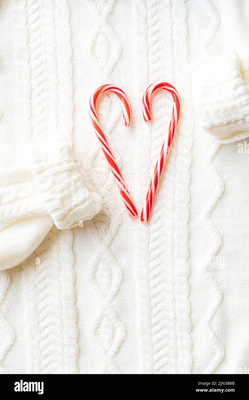 Candy cane heart for christmas design on white knitted background. X ...