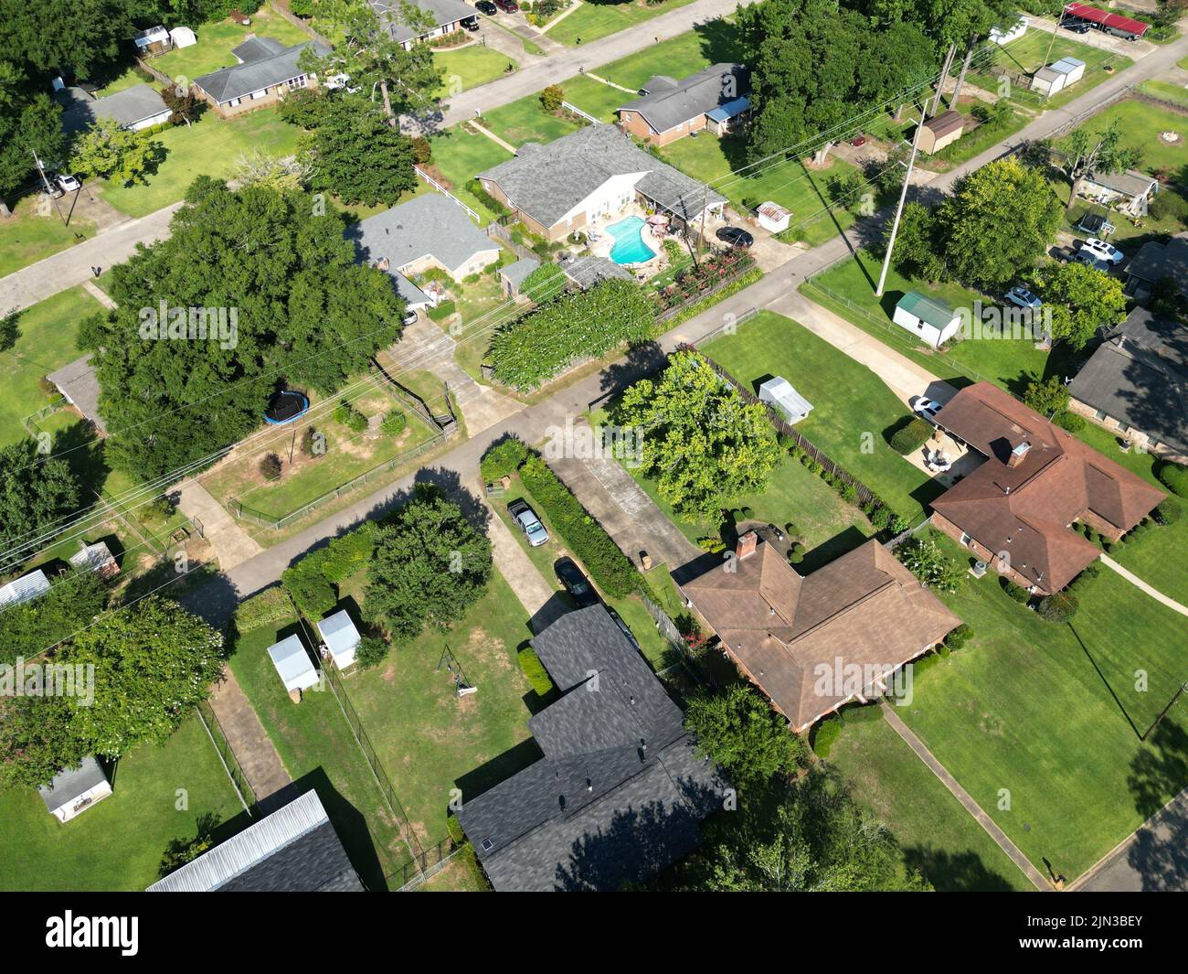 An aerial view of urban residential area with green trees, roads and ...
