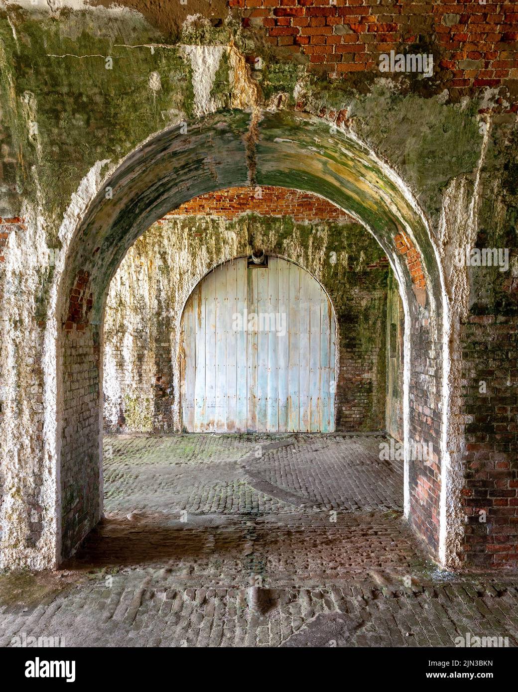 Nested arched doorways leading to a white wooden door. Significant ...