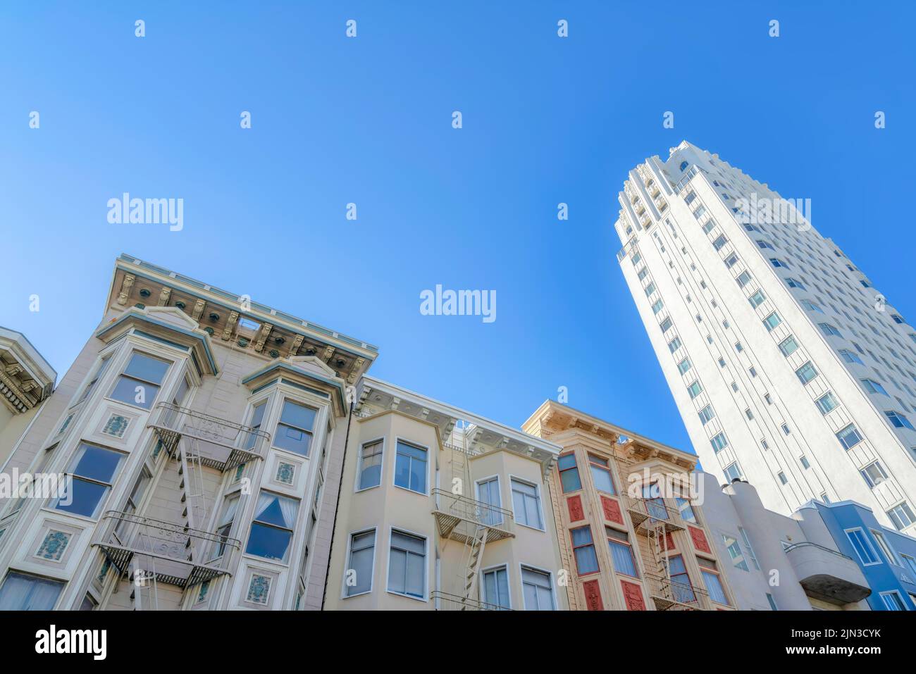 Low-rise apartment buildings beside the high-rise building in a low ...