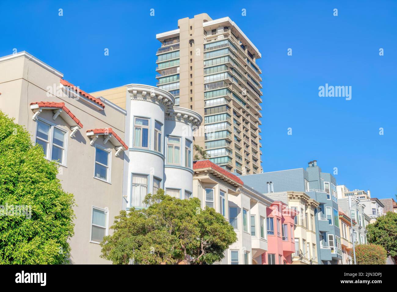 Row of victorian style apartments and a high-rise building with ...