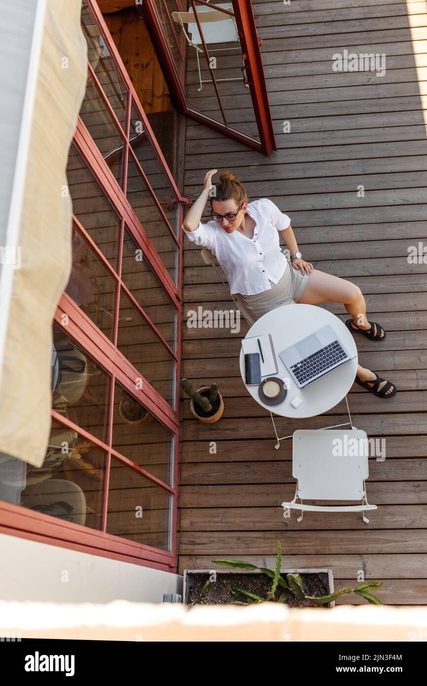 Top-down of young female copywriter typing text on laptop keyboard ...