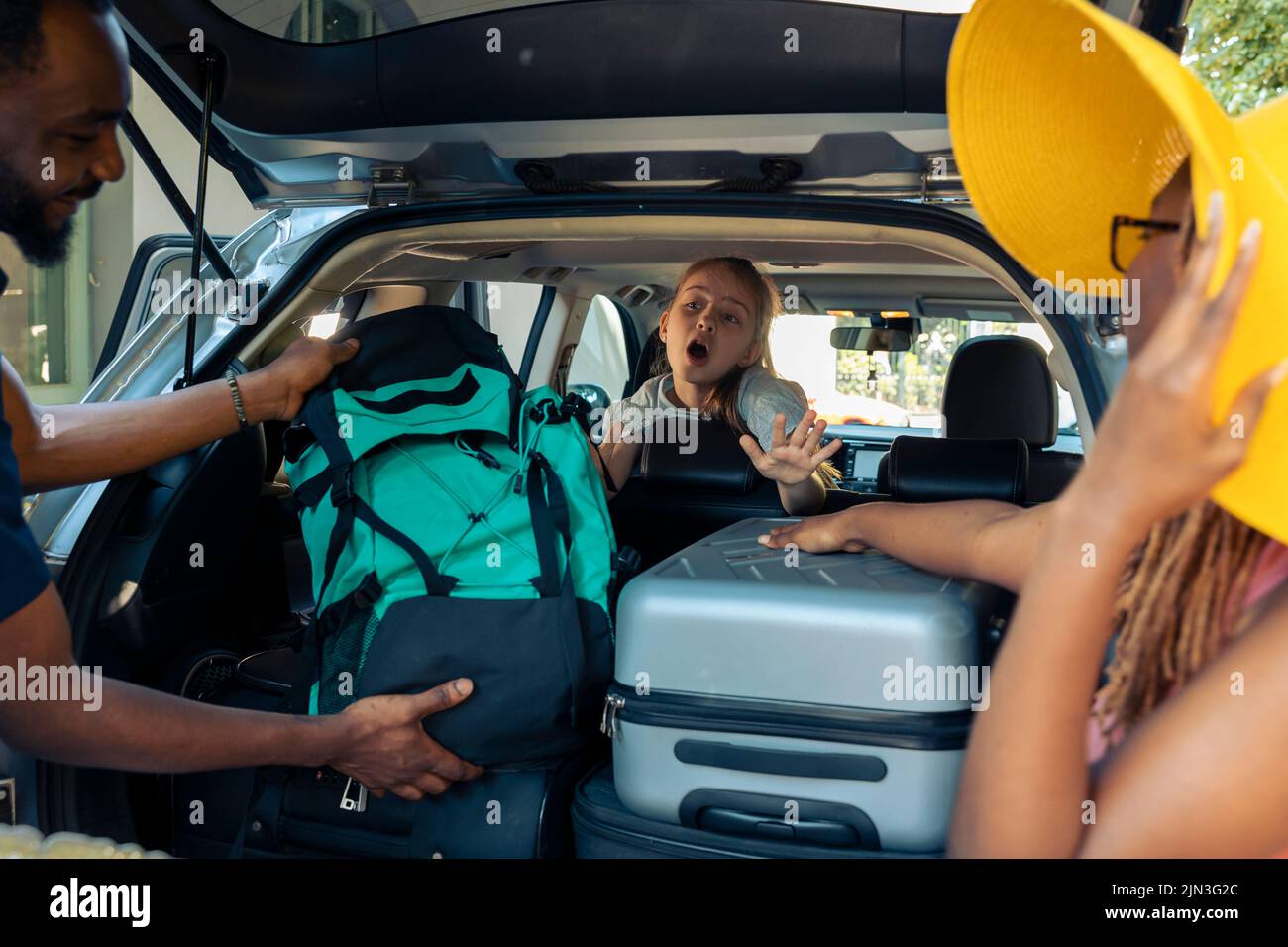 Small kid and mixed people going on vacation, loading travel bags in ...