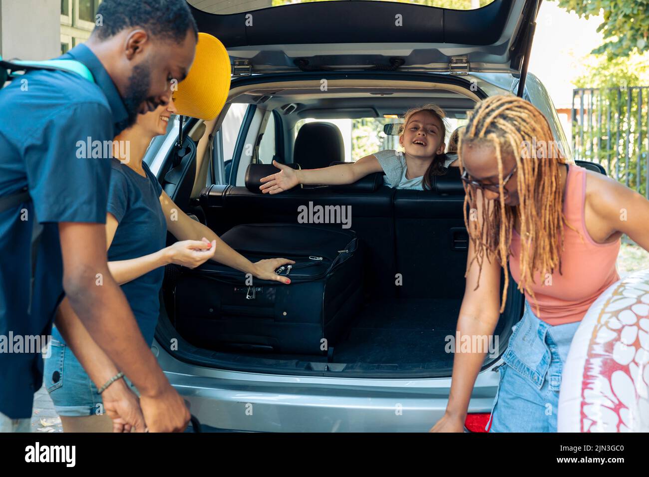 Multiethnic people travelling on summer holiday, loading baggage and ...